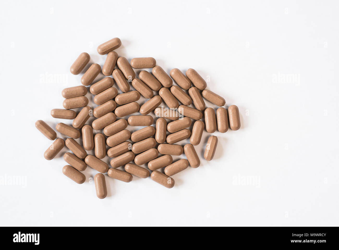 brown pills medicine isolated on white background. healthcare and ...