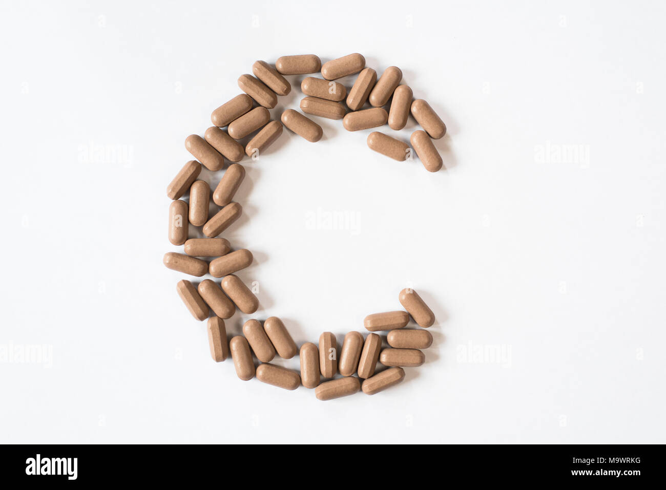 Medicine pills forming letter C, symbolic of vitamin C. healthcare and ...