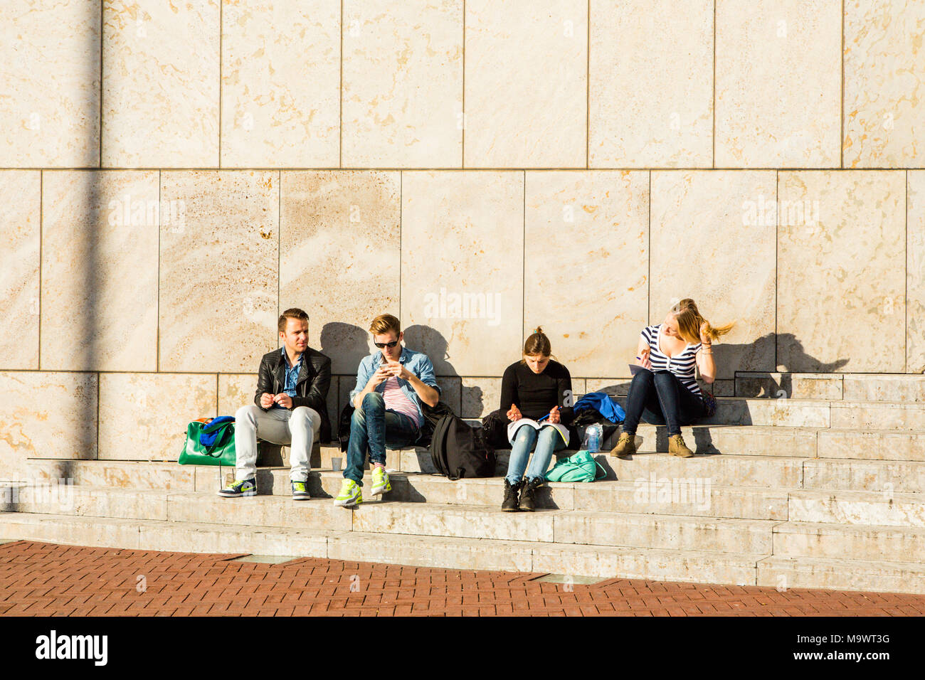 Students relaxing and studying on the stairs of the Amsterdam public ...
