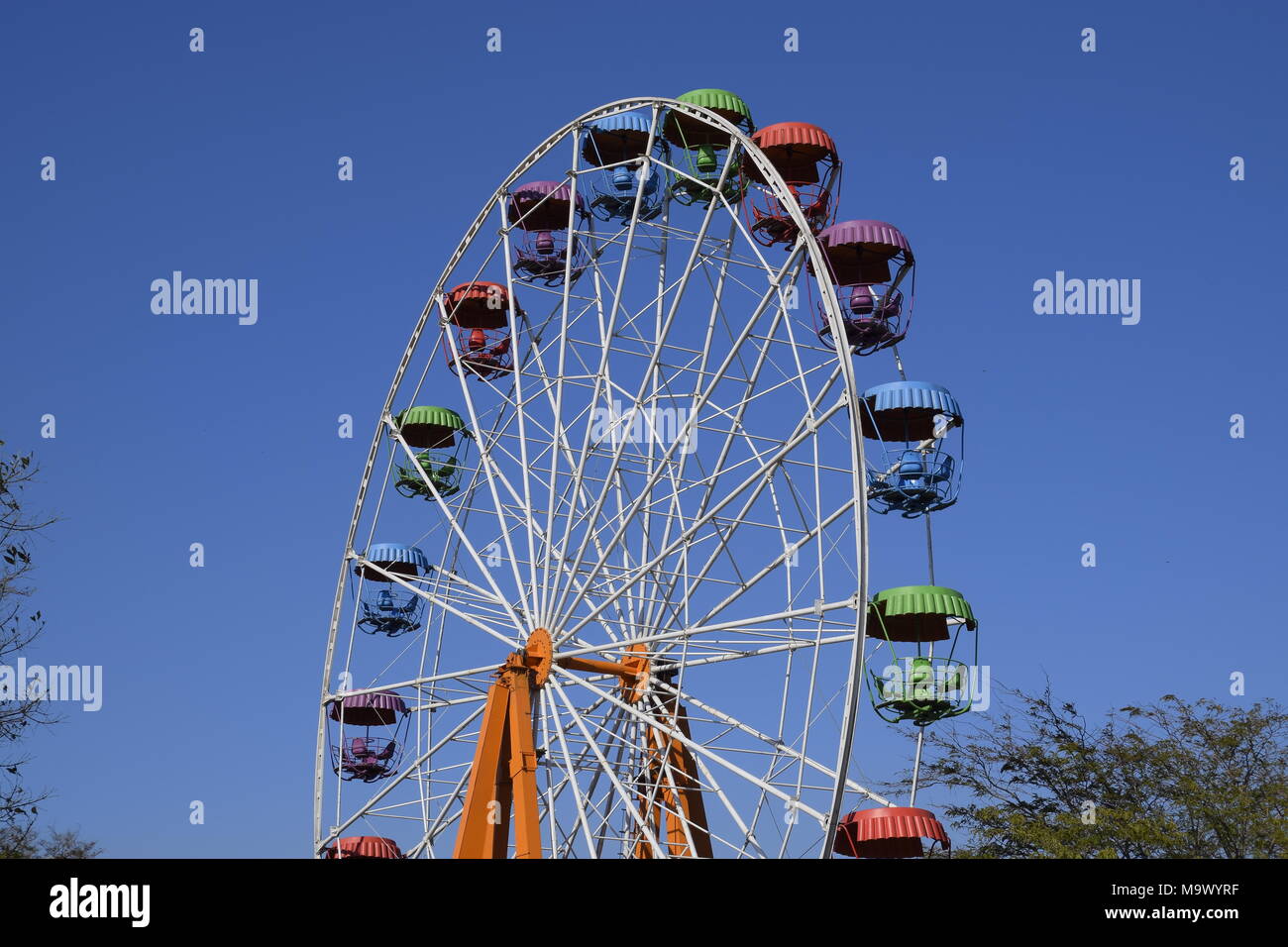 Ferris wheel. Ferris wheel in the city park. Seats for passengers on ...