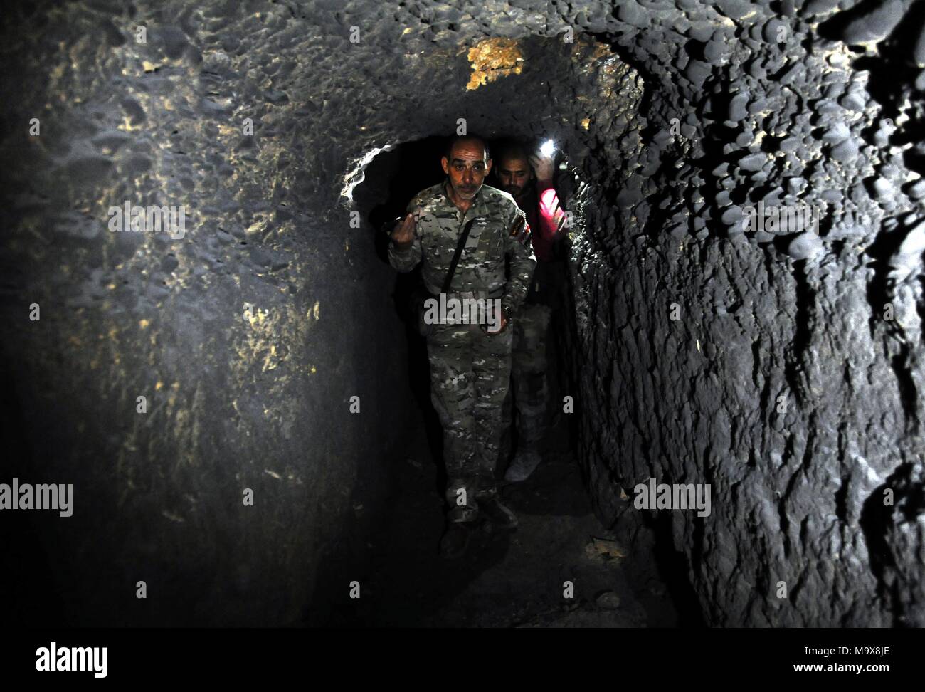 Damascus. 28th Mar, 2018. Syrian soldiers walk in a tunnel in the rebel ...