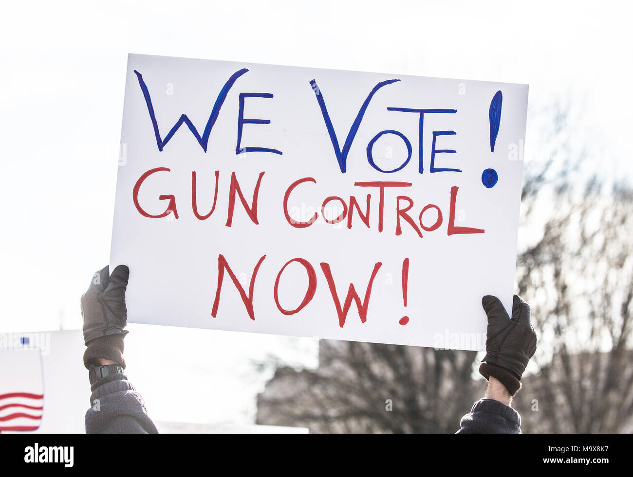 "We vote! Gun control now" reads the sign. At the "March for Our Lives ...