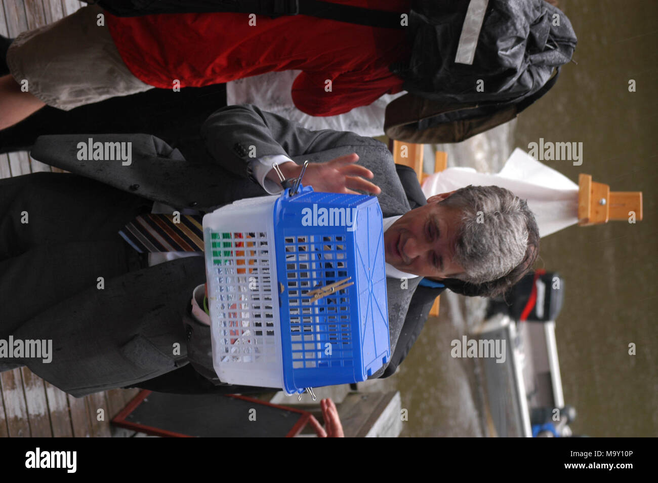 Mayor Rybak peeks at the nut-hatches inside their cage before. Mayor ...