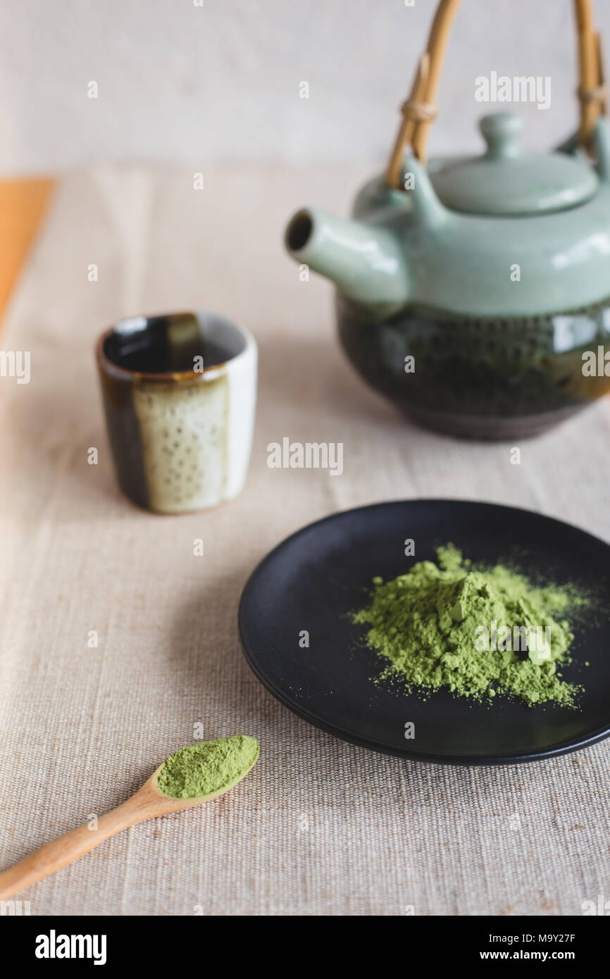 Set of matcha powder dish wooden spoon and tea pot with tea cup ...