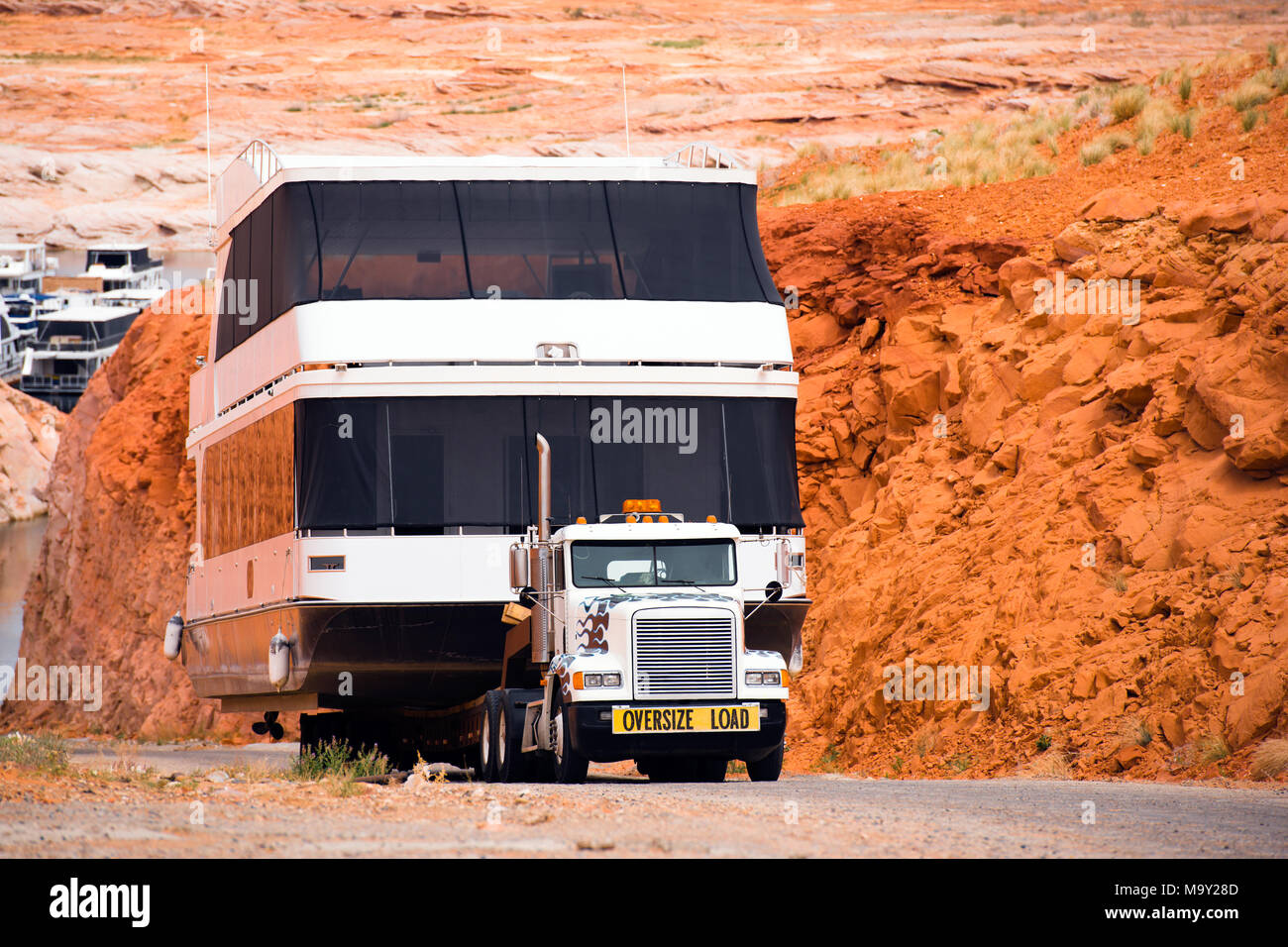 Big powerful American rig semi truck fleet go down the red rocks hill ...