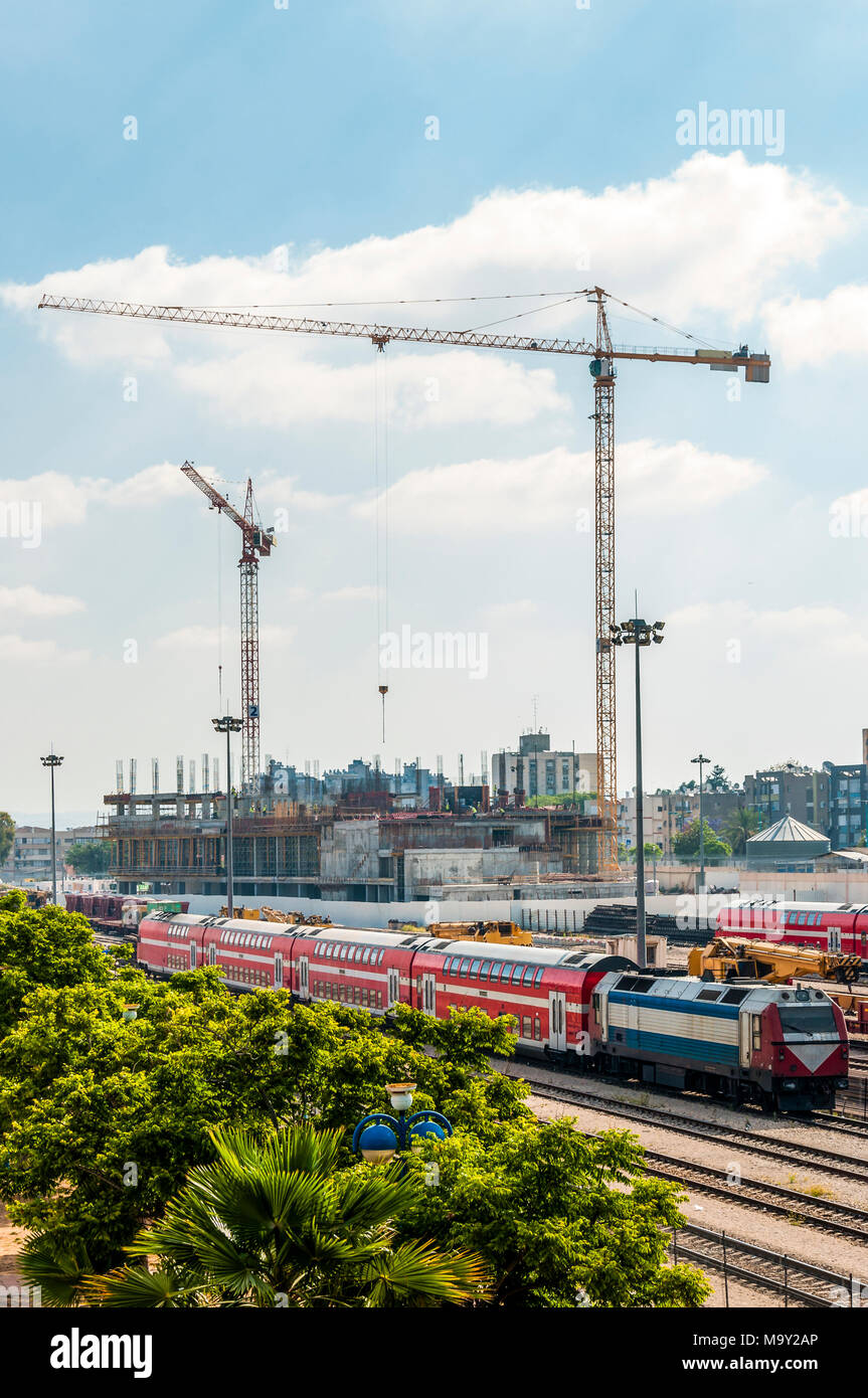Train rails platforms with construction cranes on background in Israel ...