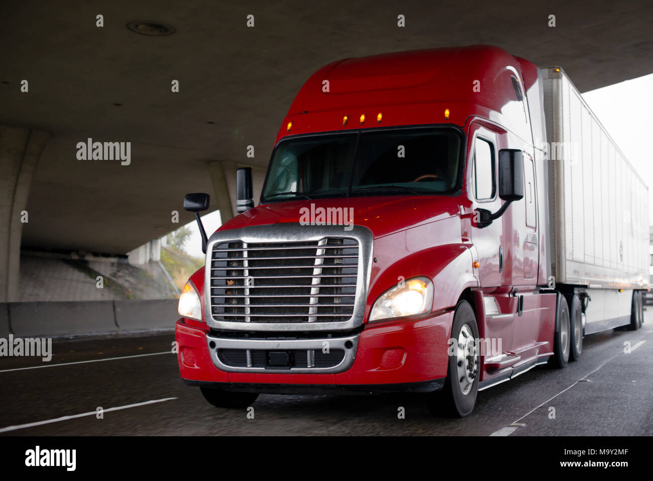 Bright red big rig modern semi truck fleet with shiny chrome grille and ...