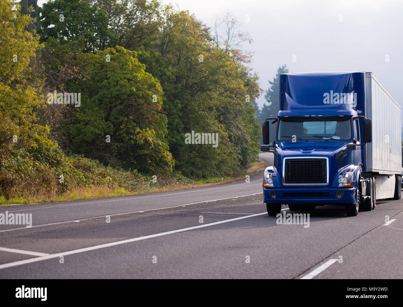 Dark blue day cab big rig semi truck fleet for community local ...