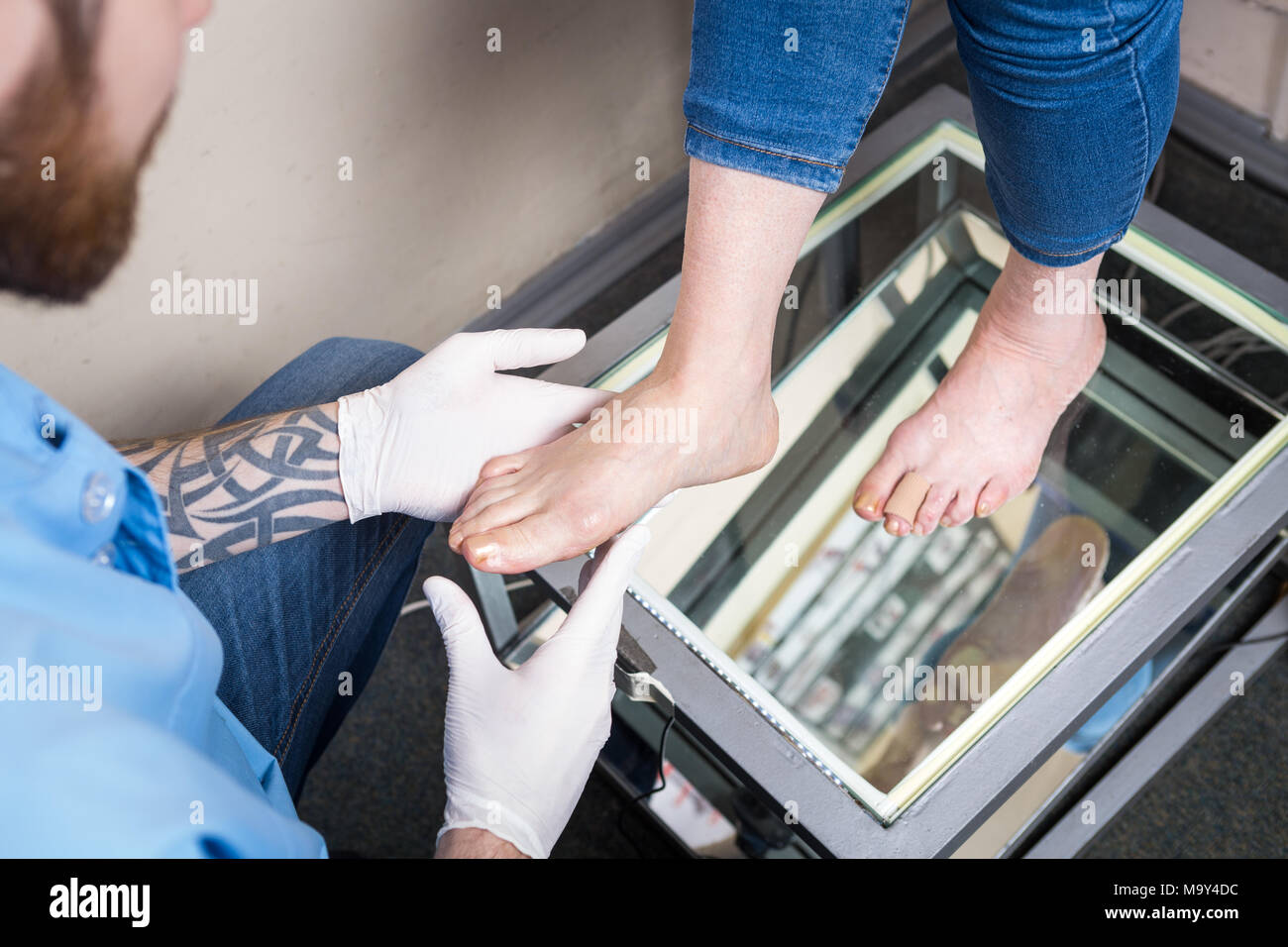 Examination of the feet of young woman hi-res stock photography and ...