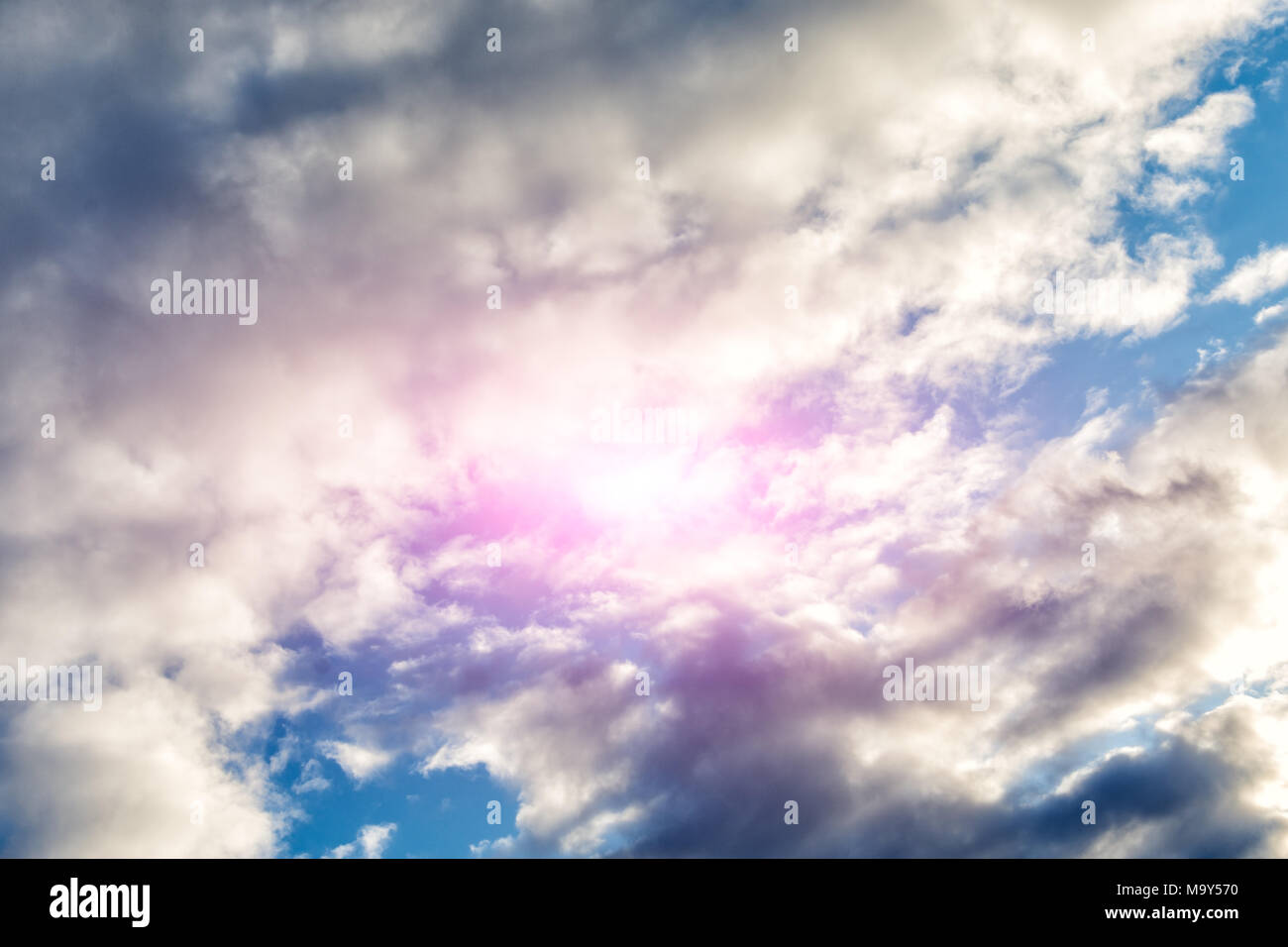texture bright contrast sky with clouds and sun rays Stock Photo - Alamy