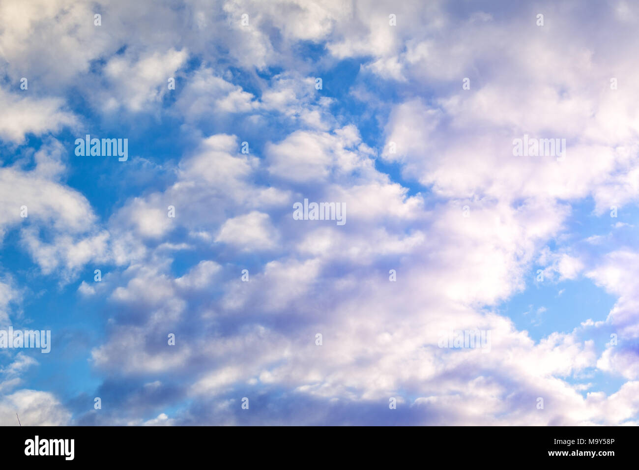 texture of the sky clouds and rays of sun on a background of blue sky ...