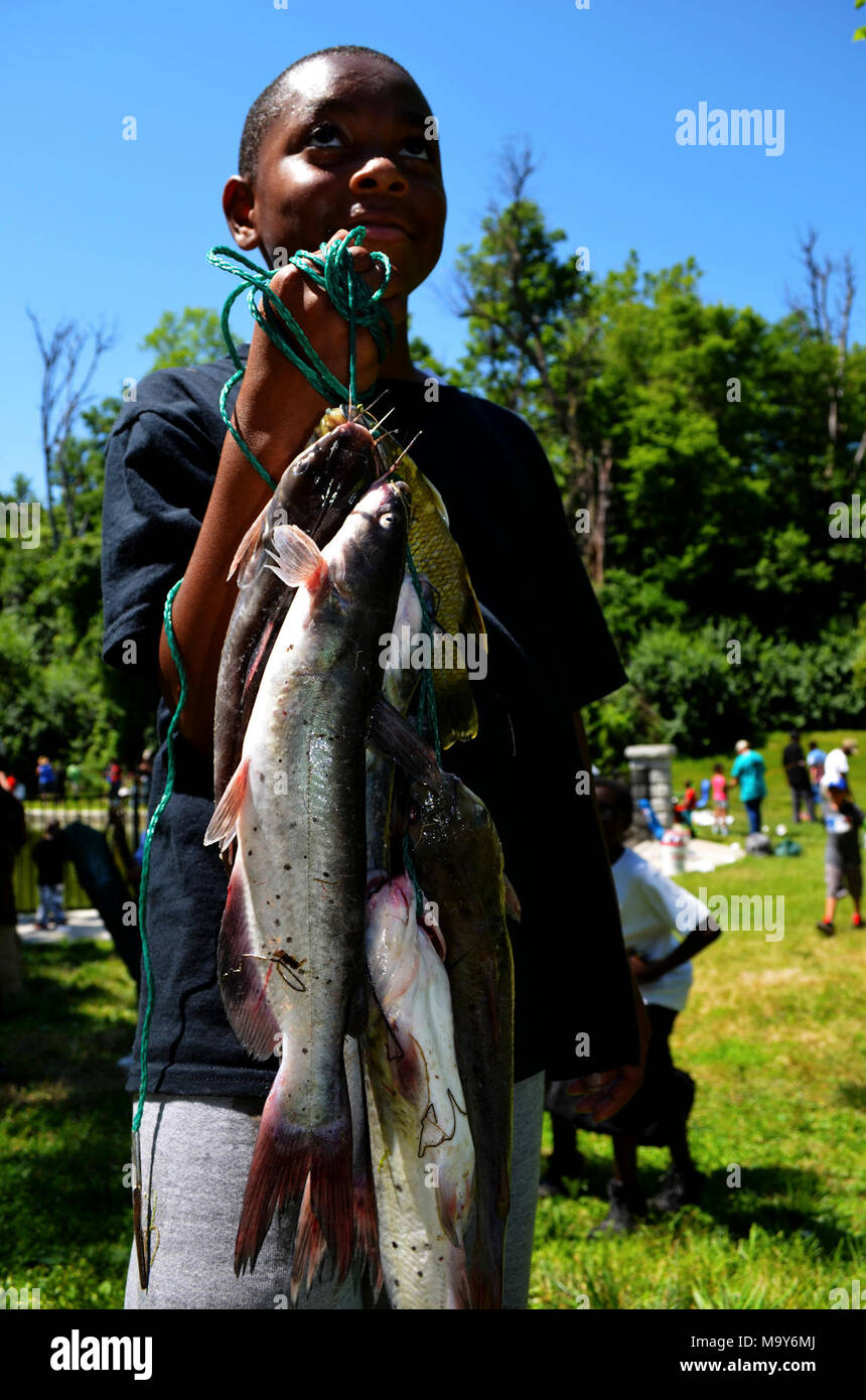 Boy with Catfish. A participants in the Urban Kids Fishing Derby in ...