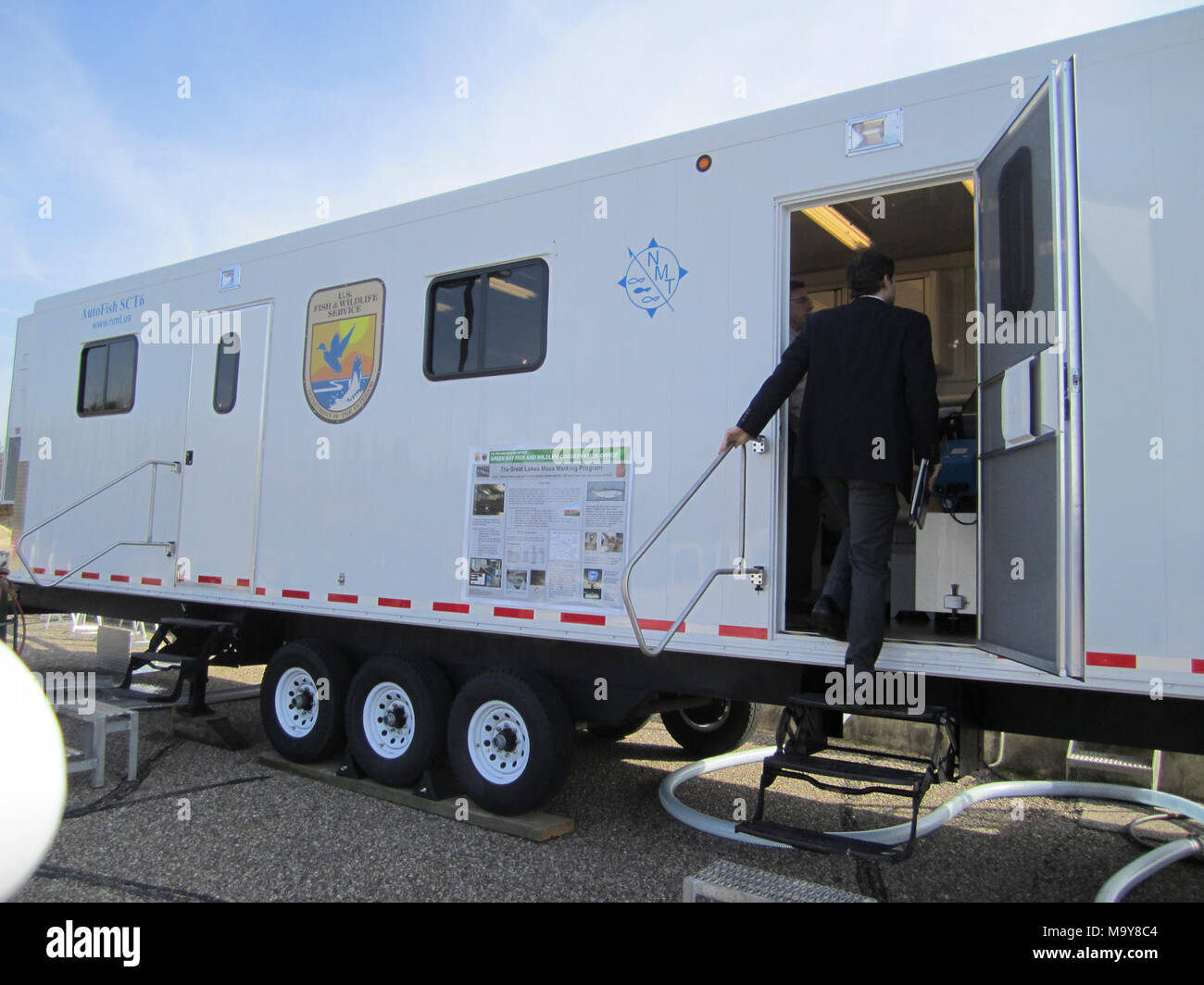 Congressional staffer entering Autofish system trailer (FWS). Exterior ...