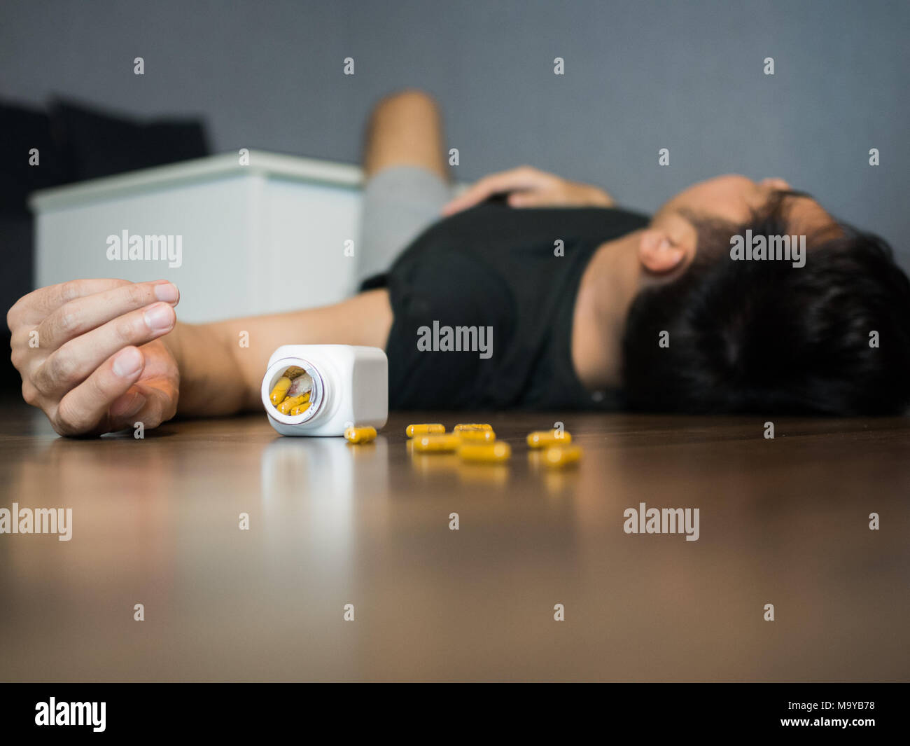 Man passing out and lying on the floor from taking medicine Stock Photo ...