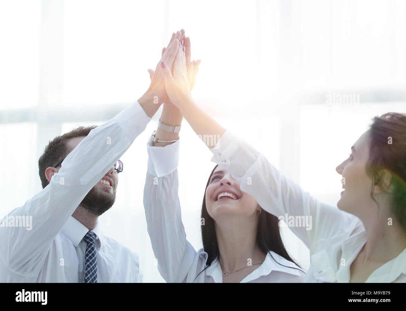 successful business team giving each other a high five Stock Photo - Alamy