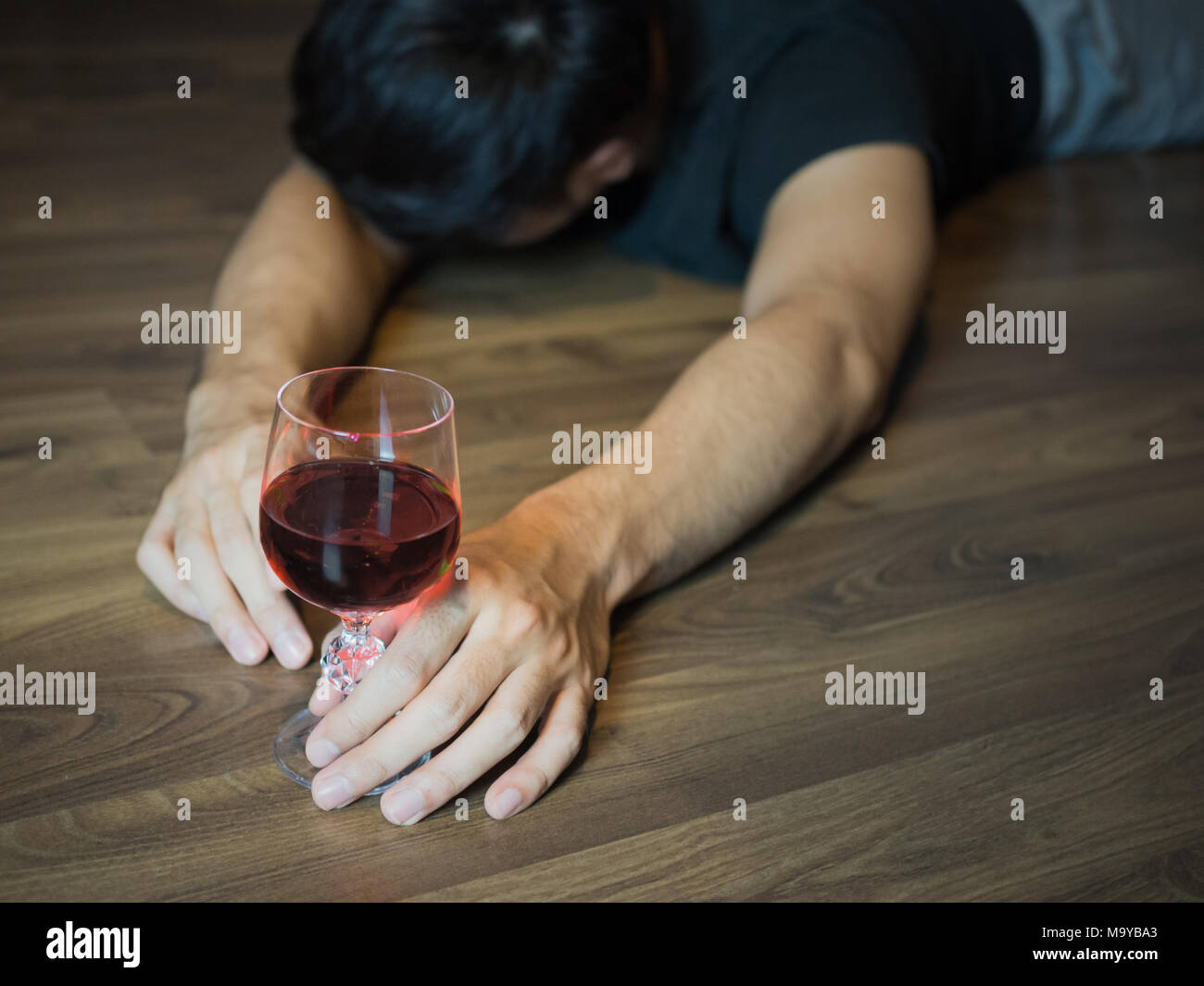 Man fall down drinking wine alcohol, pass out on the floor Stock Photo ...