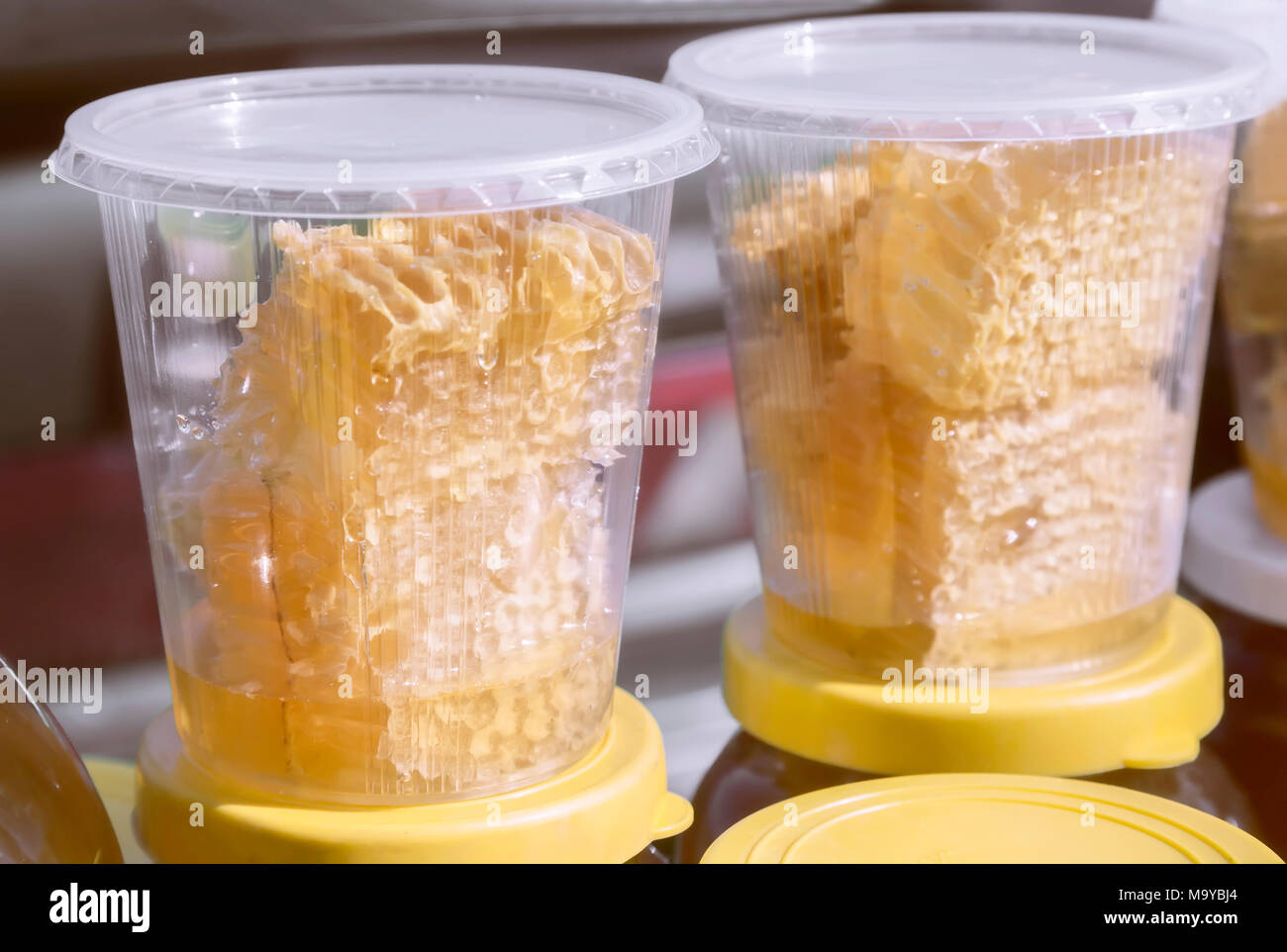 Sold at the fair bee honeycomb with honey in plastic containers Stock ...