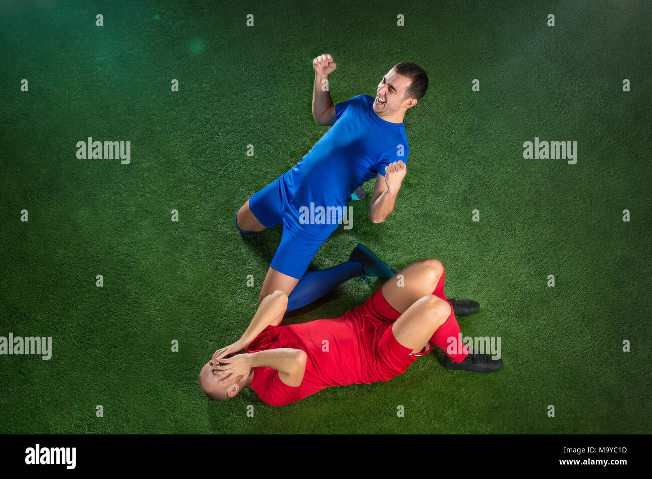 Happy and unhappy football players after goal Stock Photo - Alamy