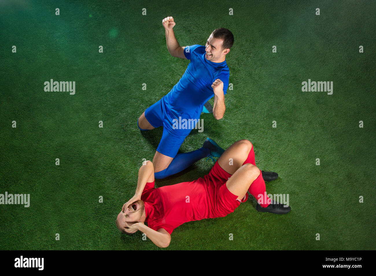 Happy and unhappy football players after goal Stock Photo - Alamy