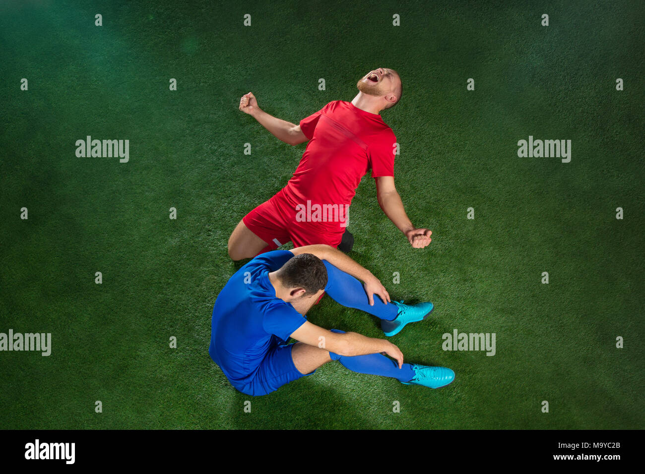 Happy and unhappy football players after goal Stock Photo - Alamy