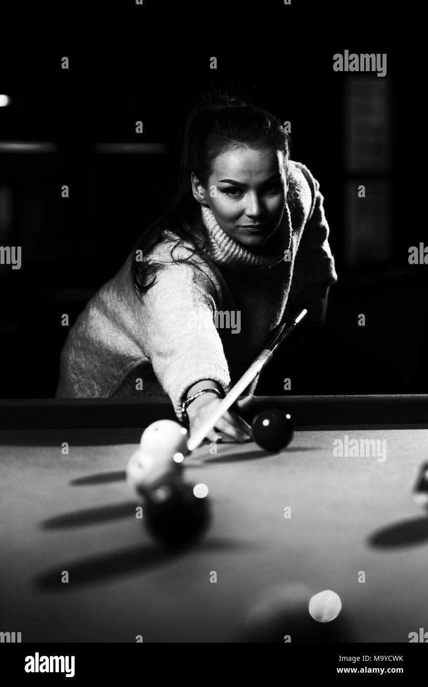 Young Woman Lining To Hit Ball On Pool Table Stock Photo - Alamy