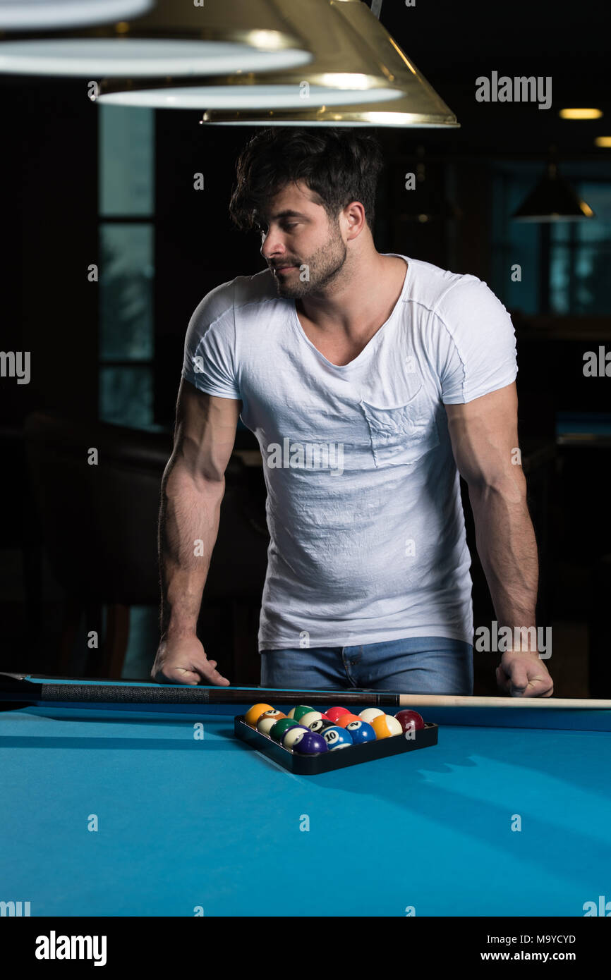 Portrait Of A Young Man Playing Billiards Pool Game Stock Photo - Alamy