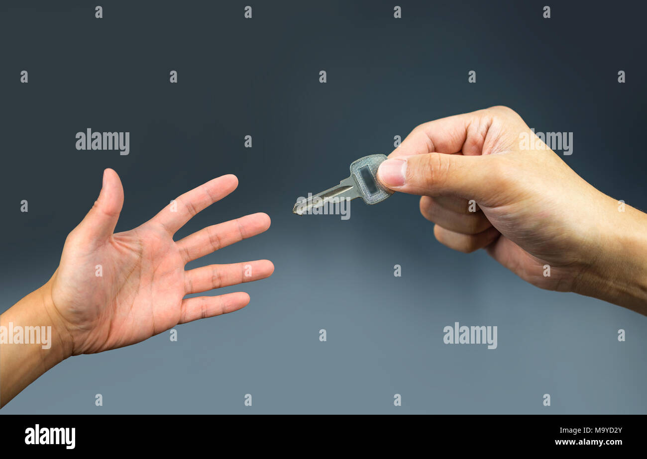Give key to someone else Stock Photo - Alamy