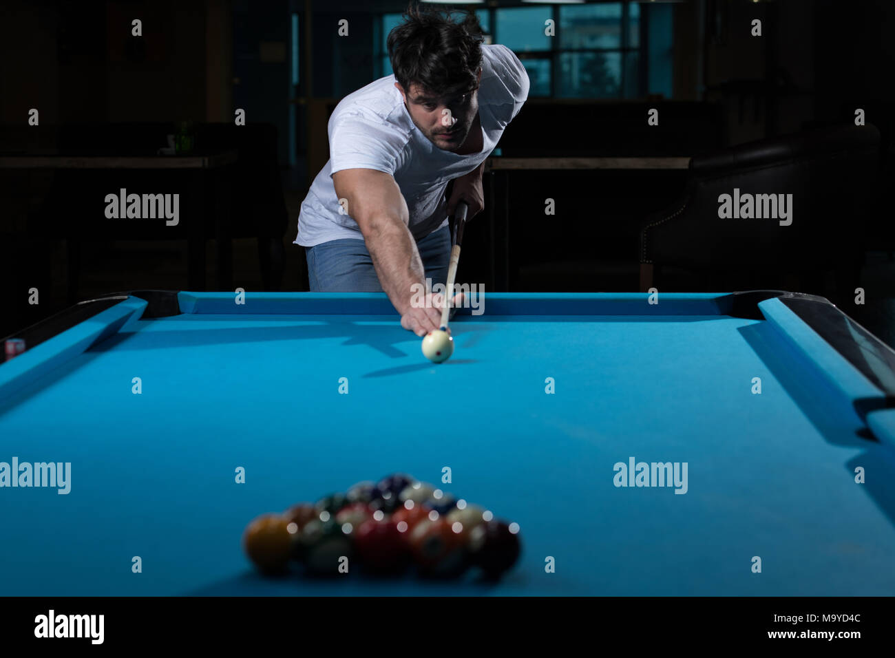 Young Man Playing Billiards Lined Up To Shoot Easy Winning Shot Stock ...