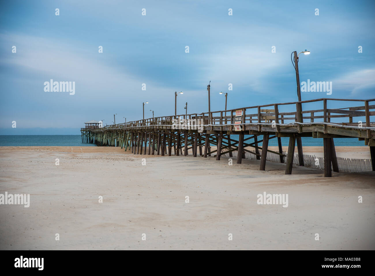 Sunrise with the Atlantic Beach pier in the background with sand, ocean ...