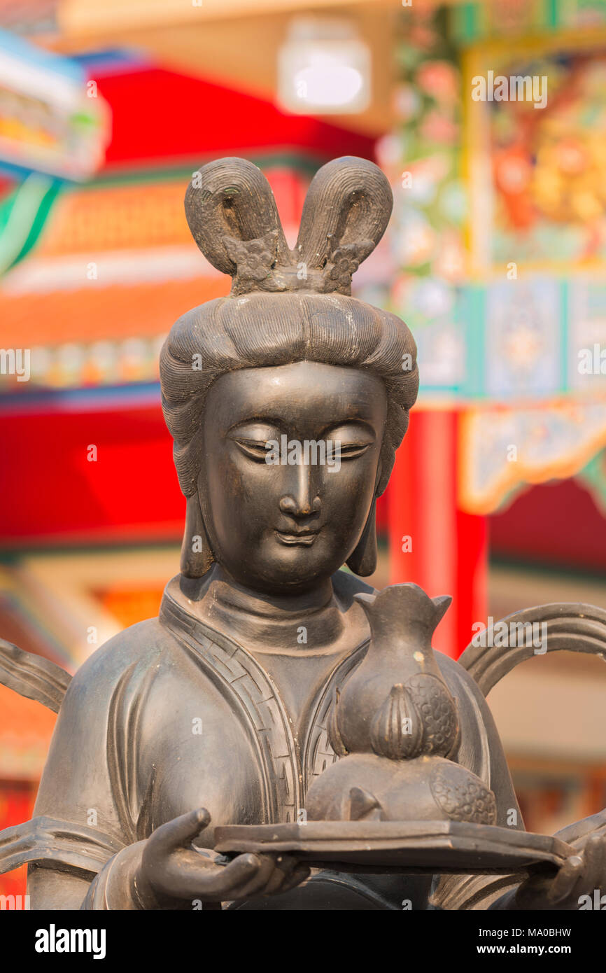 Chinese Girl statue holding a pitcher of tea Stock Photo - Alamy