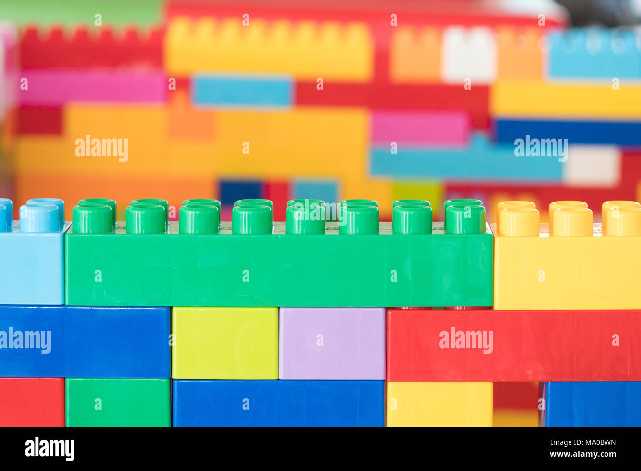 Colorful stacked toy plastic building blocks Stock Photo - Alamy