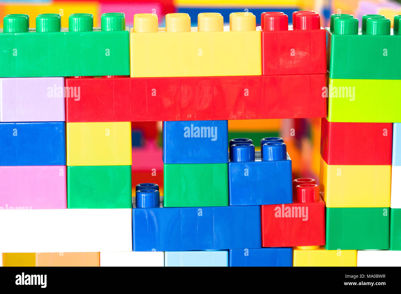 Colorful stacked toy plastic building blocks Stock Photo - Alamy