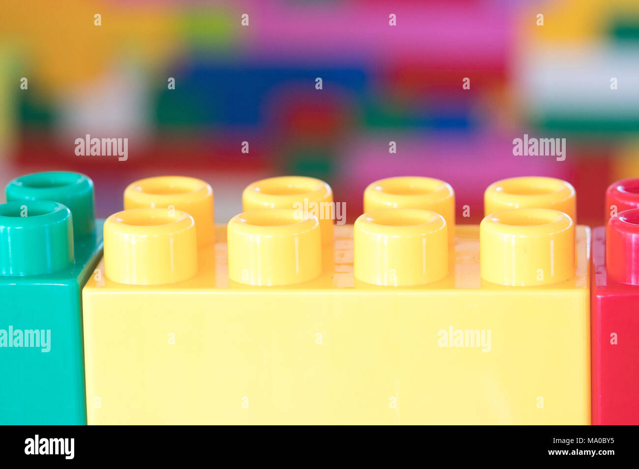 Colorful stacked toy plastic building blocks Stock Photo - Alamy