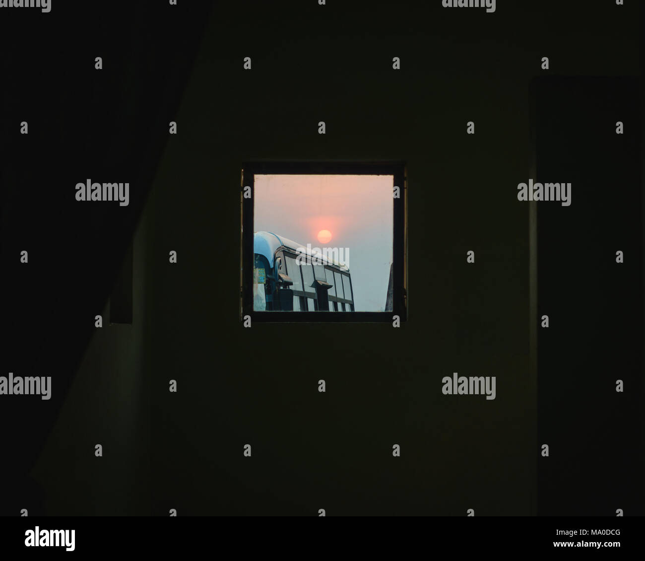 Sunrise seen through a small square window at Kathmandu airport. Lots ...