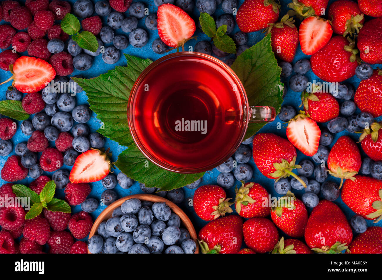 Cup of herbal tea with berries mix of strawberry, blueberry, raspberry ...