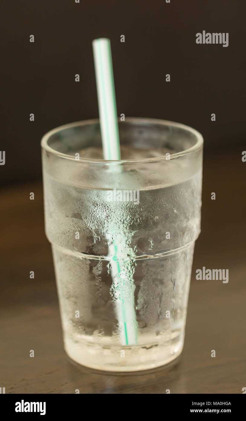 Glass of pure water with ice and drinking straw Stock Photo - Alamy