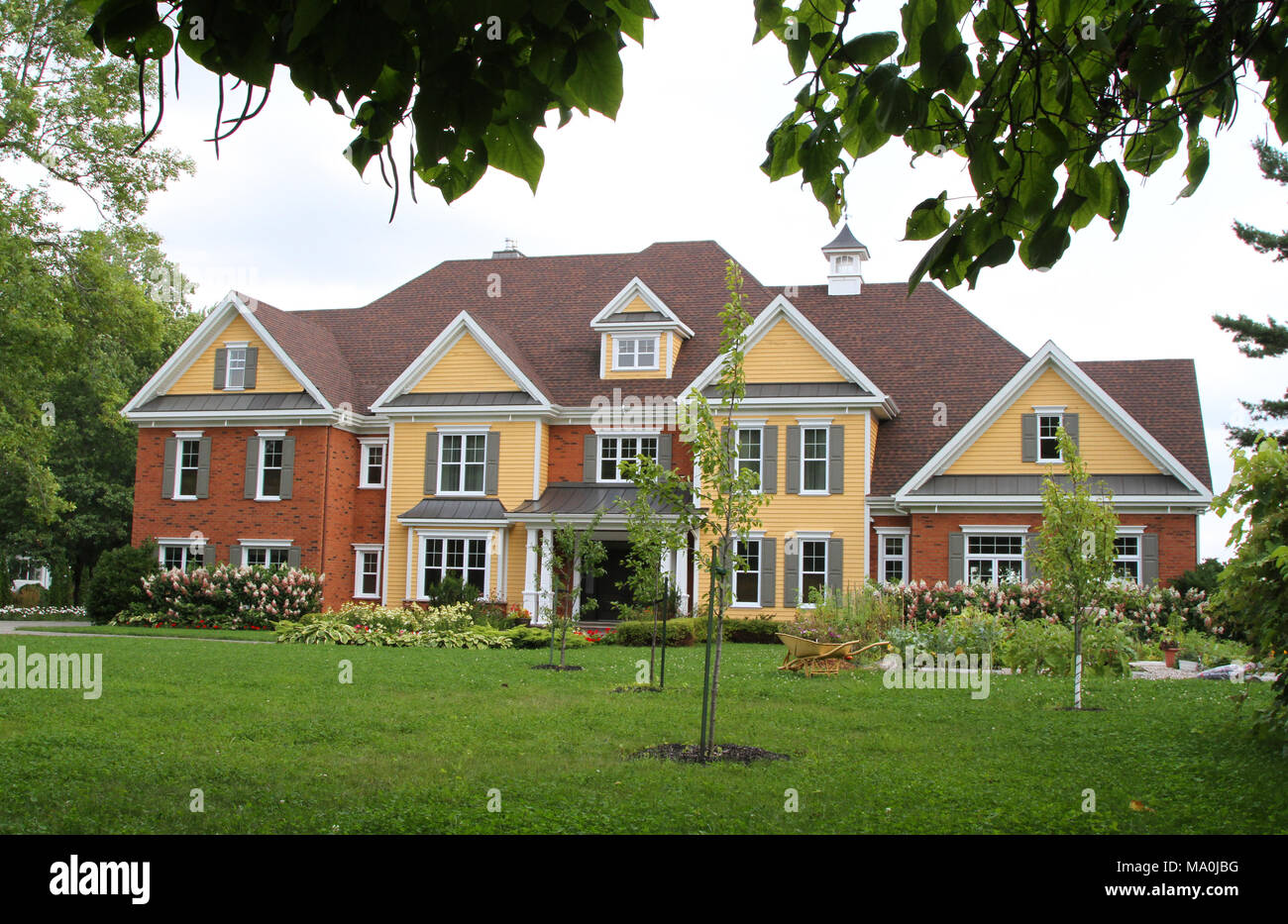 Colorful mansion with manicured gardens Stock Photo - Alamy
