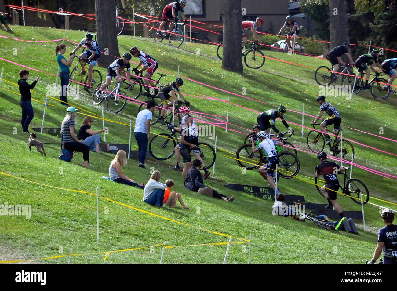 Cyclists portage their bikes up the stairs during a lap in an amateur ...