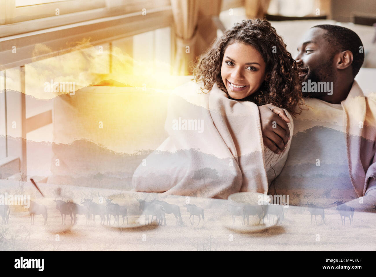 Cheerful couple sitting close to each other Stock Photo - Alamy