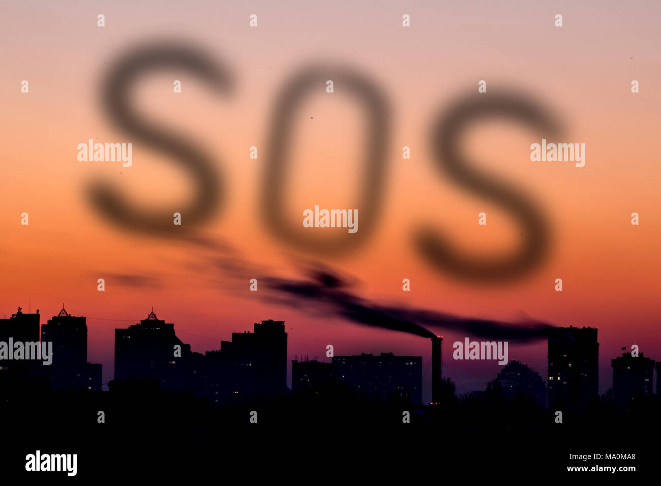 Cityscape with dramatic sky sunset. Silhouette of buildings and smoking ...