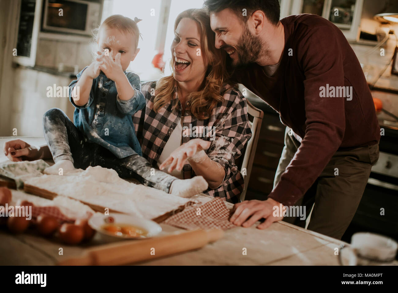 Happy family making pasta in the kitchen at home Stock Photo - Alamy