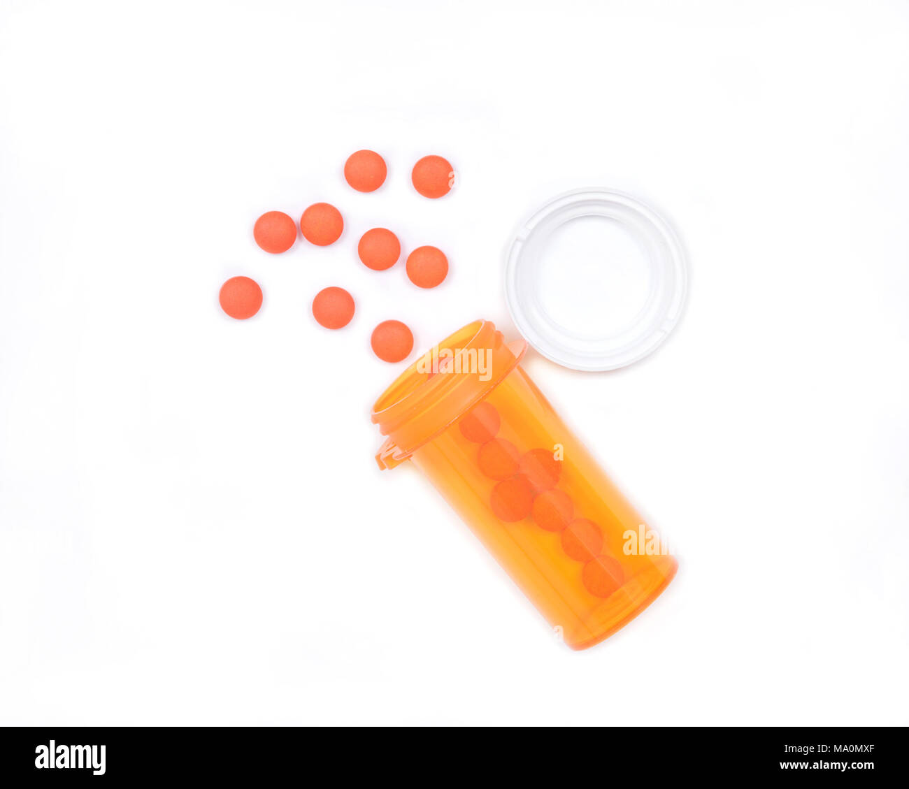 Orange pills in plastic bottle with a cap isolated on white background ...