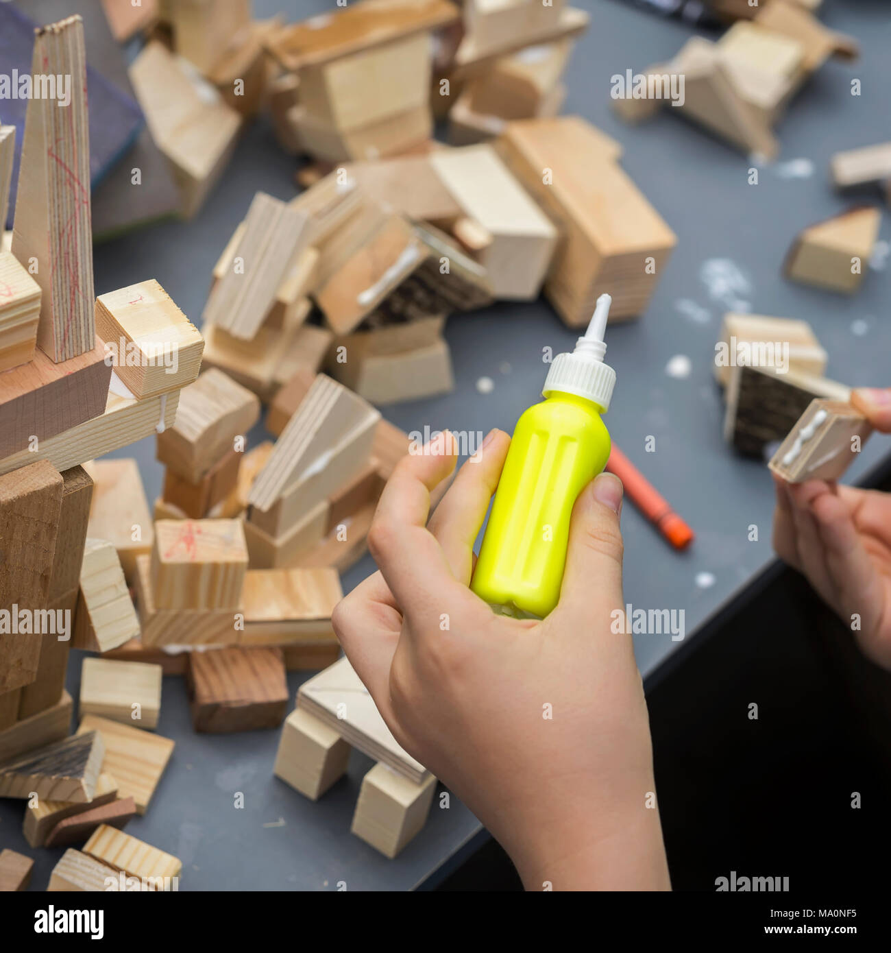 Close-up of child's hands playing with wooden constructor, bricks on ...