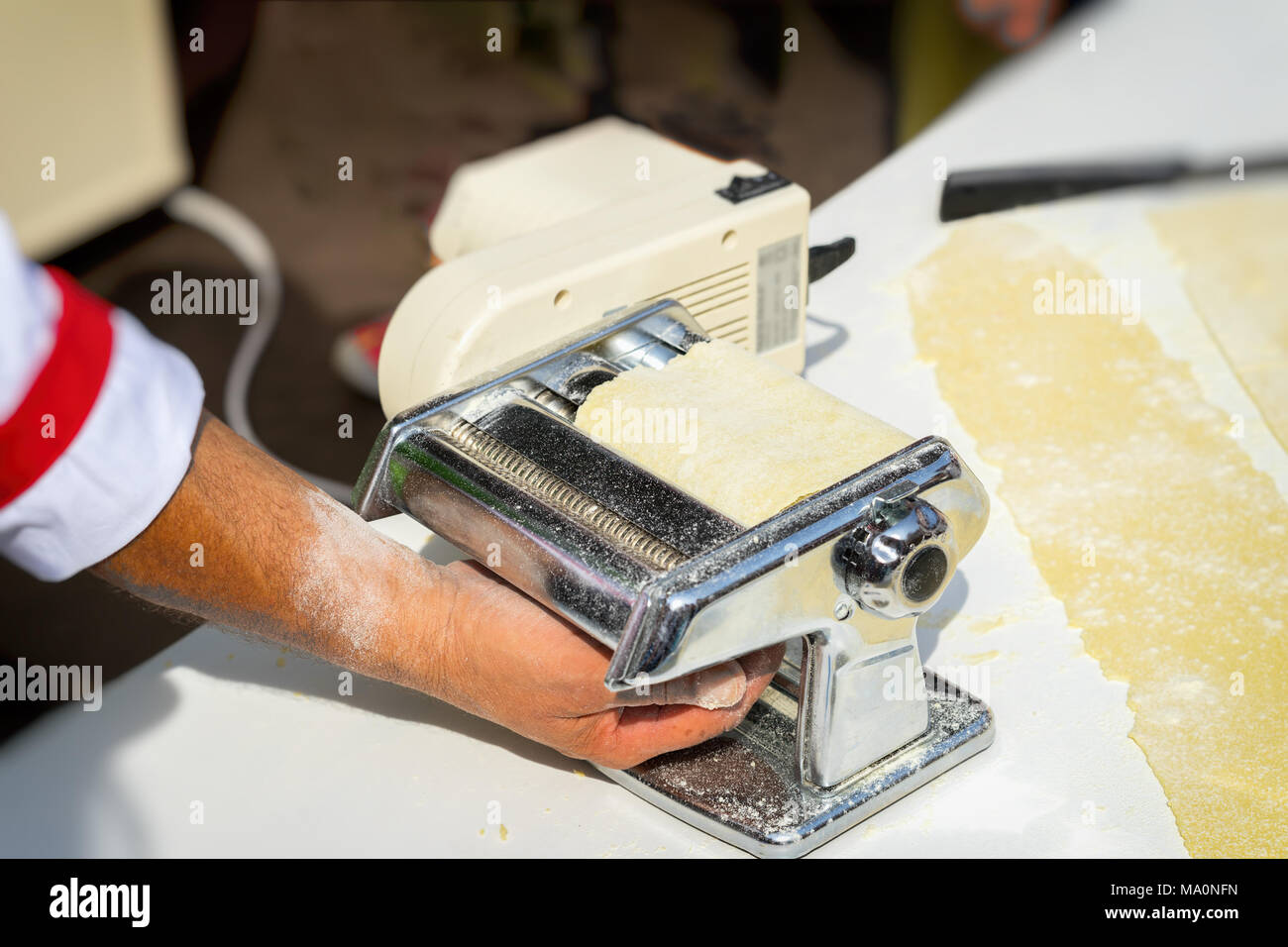 Preparing fresh homemade pasta, noodles with traditional rolled pasta ...