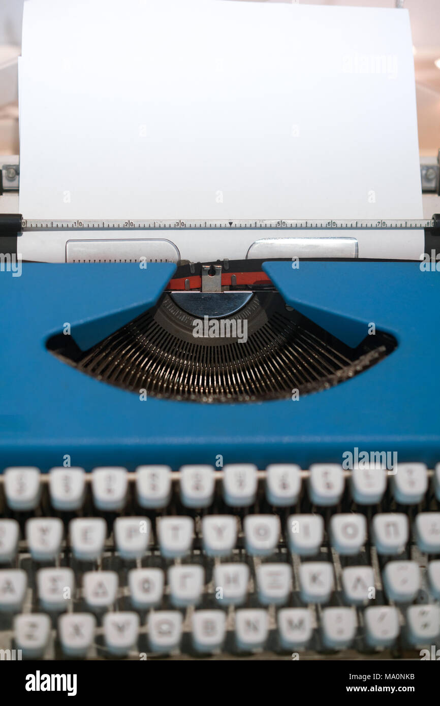 Old Typing Machine, with blank white sheet, waiting for your ideas ...