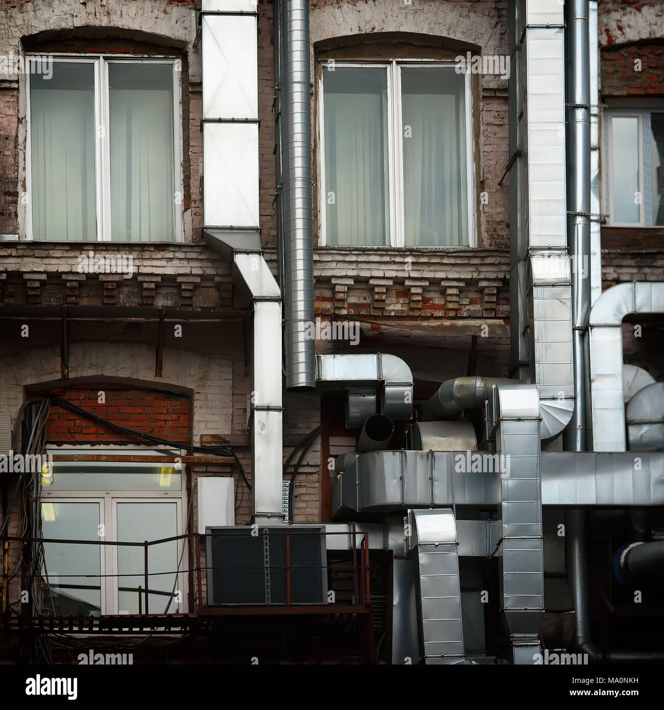 Aluminum ventilation pipes outside the old Industrial brick building of ...