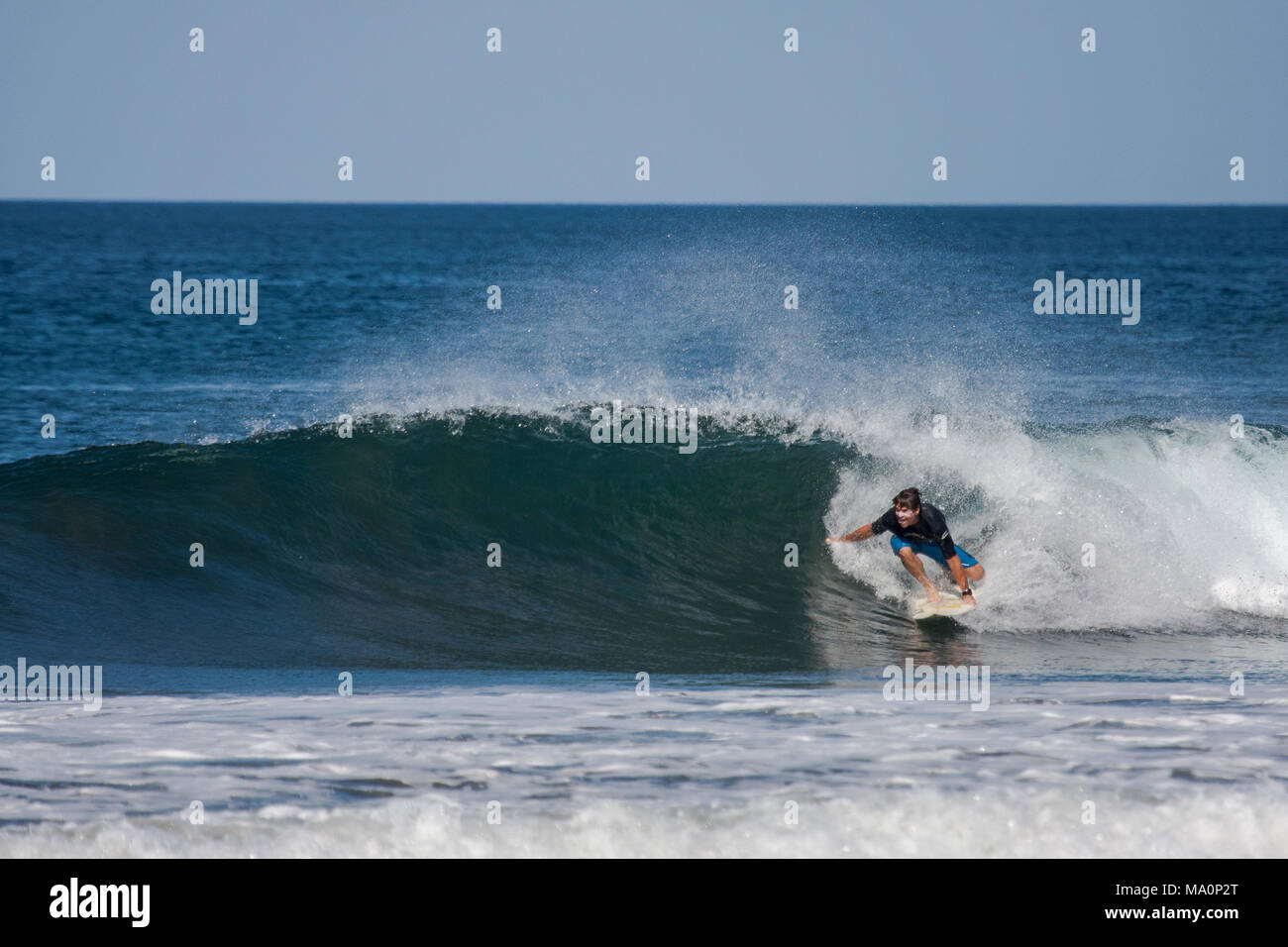 Random surfer on a secret wave in Costa Rica Stock Photo - Alamy