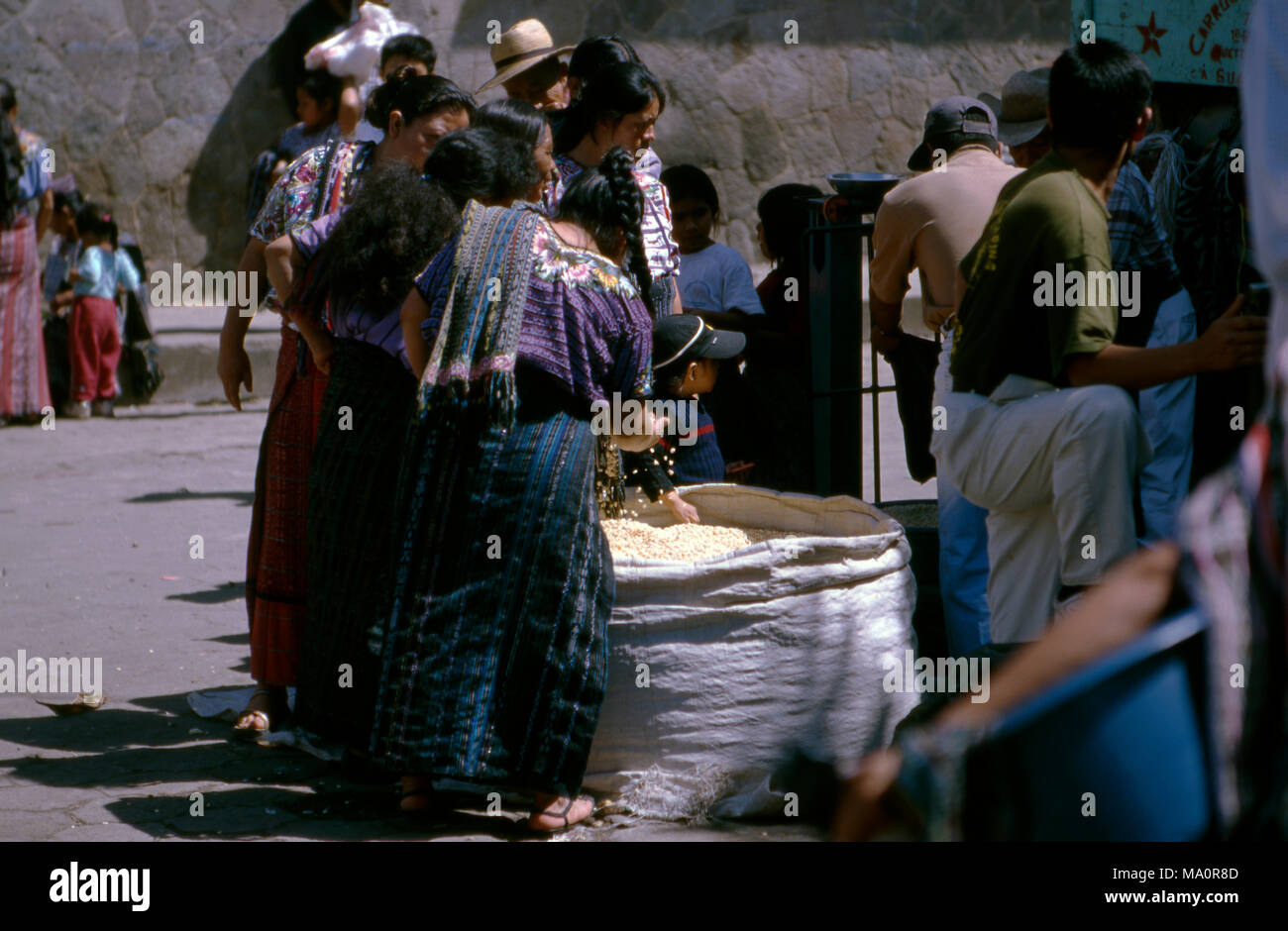 Indigenous Tz'utujil Mayan women buying corn (maize) at the market in ...
