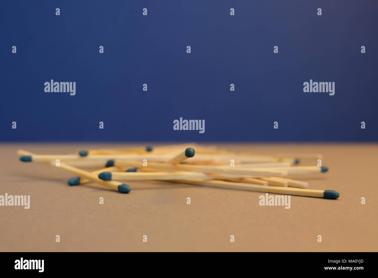Blue head matchsticks in random pile with blue background Stock Photo ...