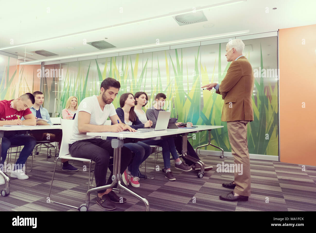 group of students study with professor in modern school classroom Stock ...